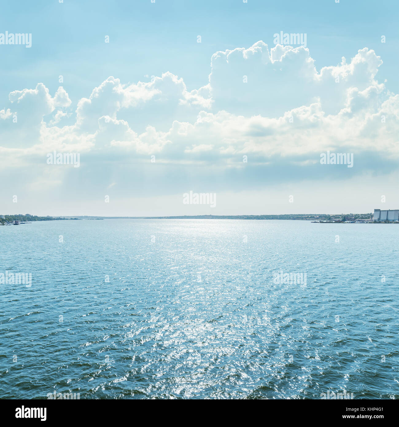river with reflections of sun under blue sky with clouds Stock Photo ...