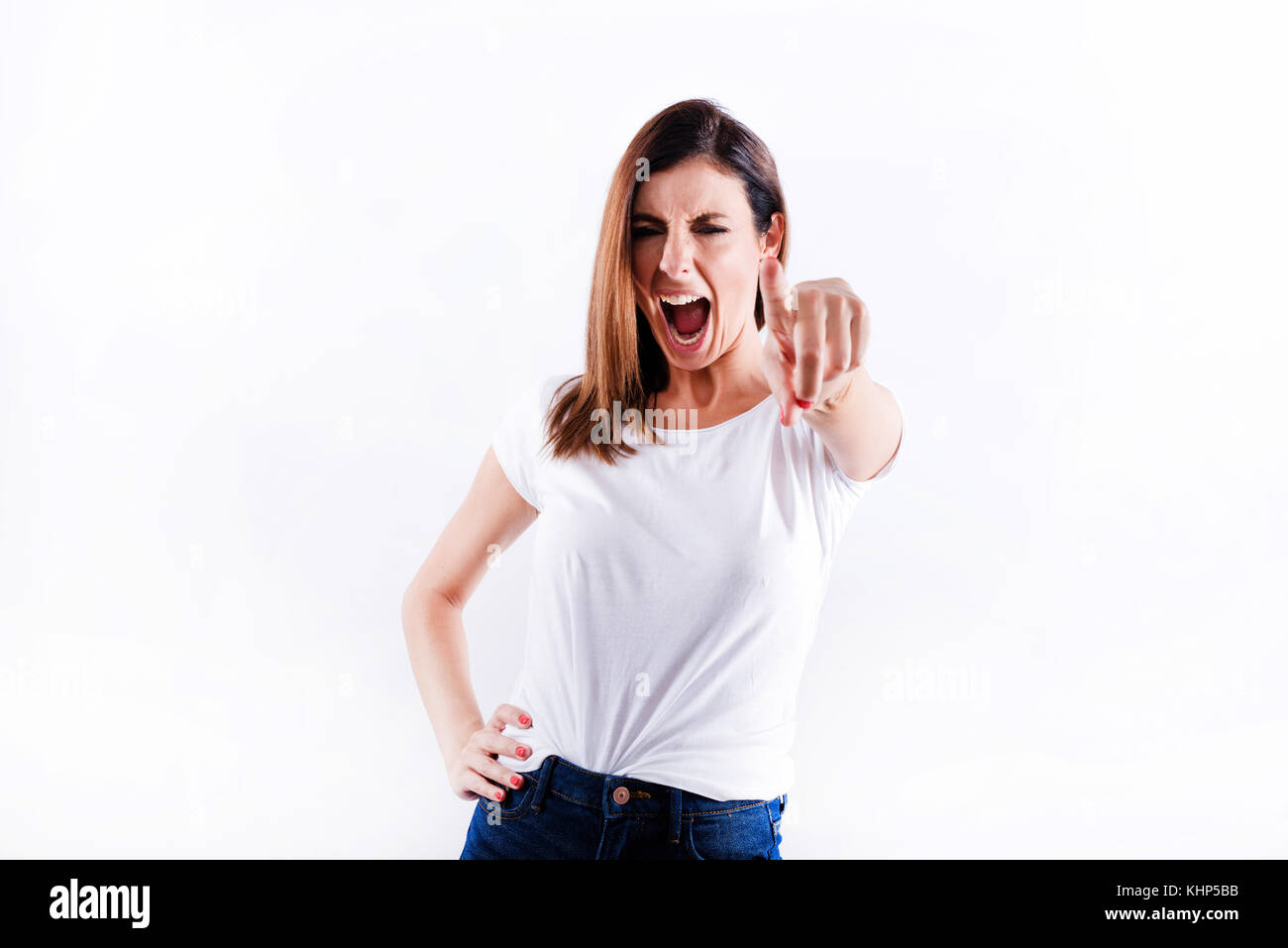 A beautiful young woman pointing to the camera and screaming Stock ...