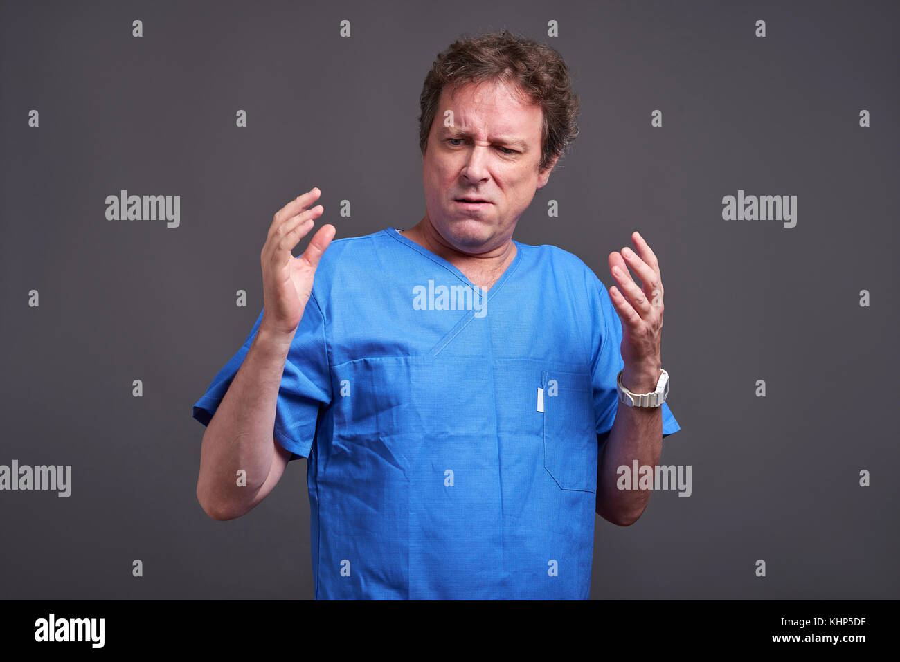 A middle aged male doctor standing and feeling scared Stock Photo - Alamy