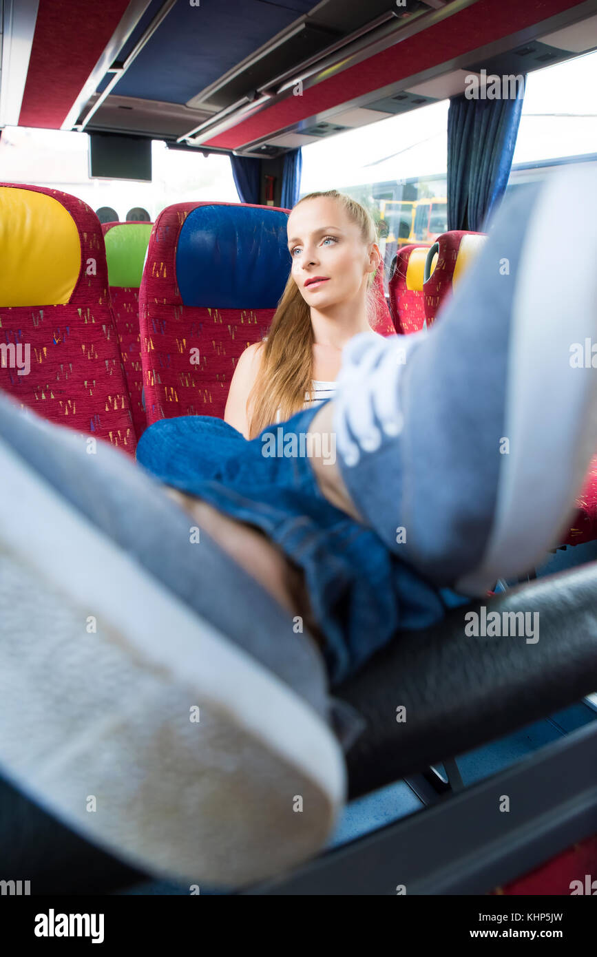 A young woman sitting comfortably on the bus Stock Photo - Alamy