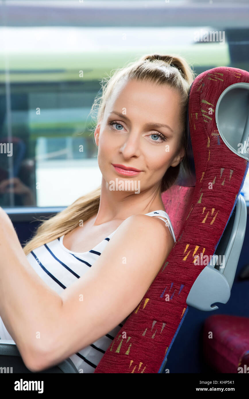 A young woman sitting comfortably on the bus Stock Photo - Alamy
