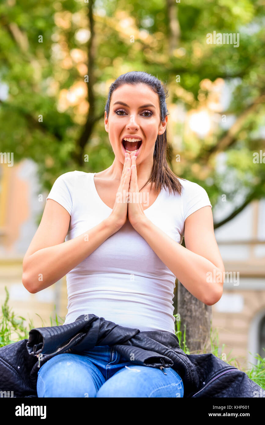 Portrait of a happy young woman being cheerful in a Park Stock Photo ...