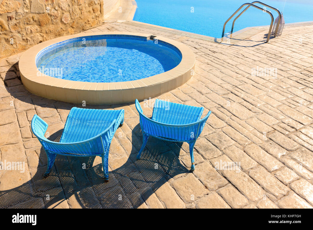 closeup of a small pool with blue stylish sunbeds Stock Photo - Alamy