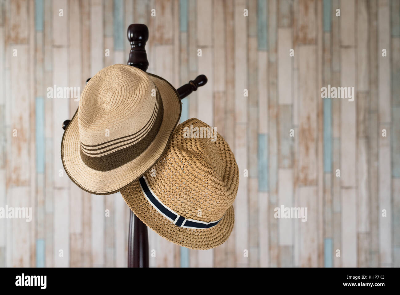 Straw hat hanging on wooden hanger.clothing accessories and travel ...