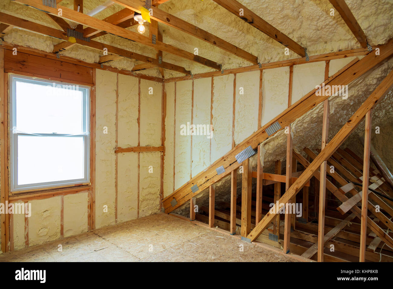 A room at a newly constructed home is sprayed with liquid insulating ...