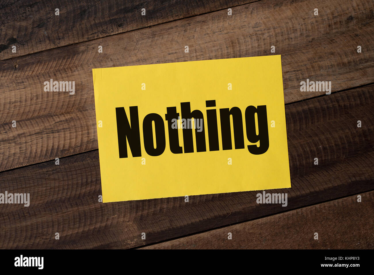nothing word on paper.piece of paper written "nothing" on a wooden ...