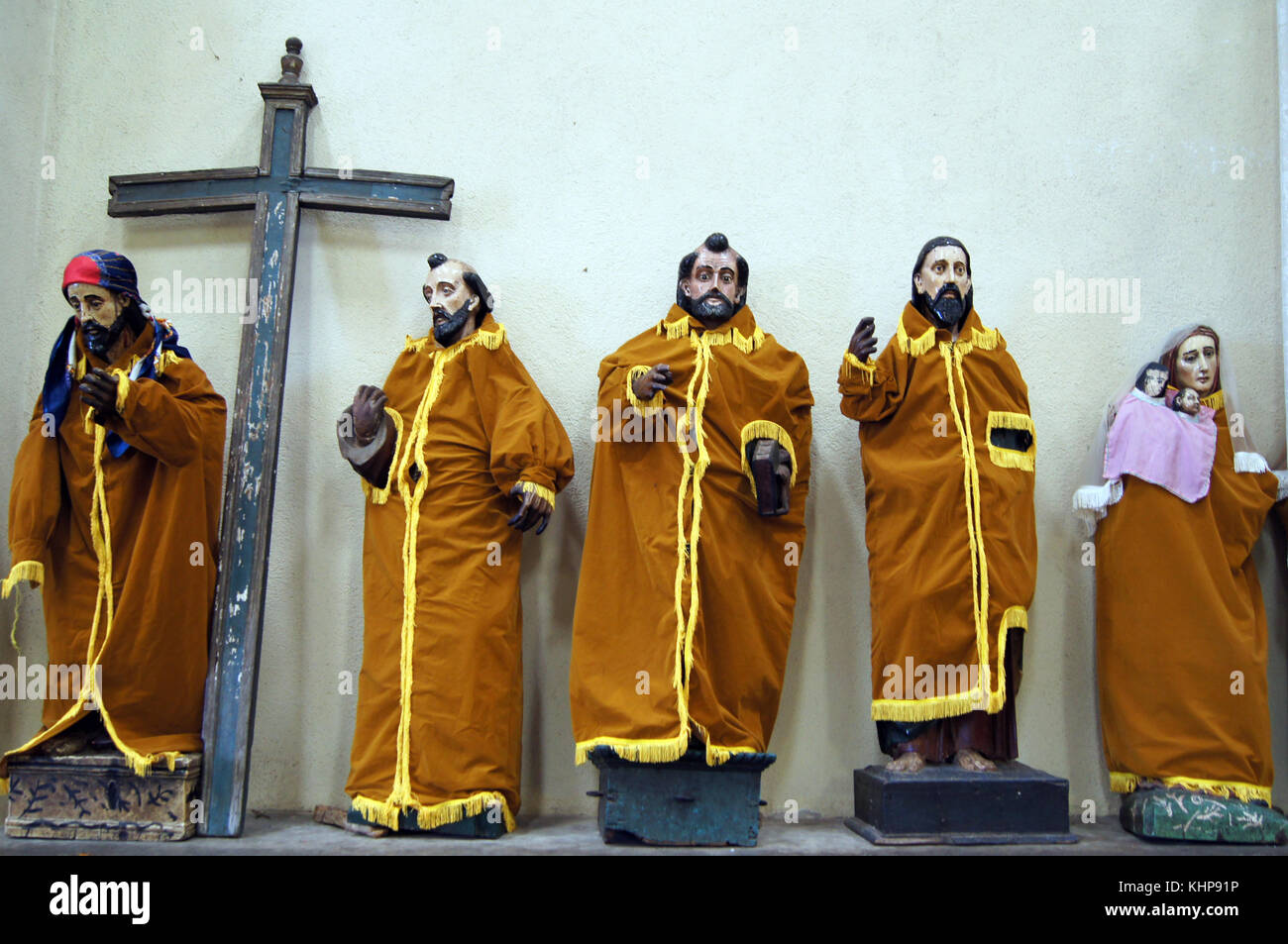 Cross and saints near the wall in church in Santiago de Atitlan ...