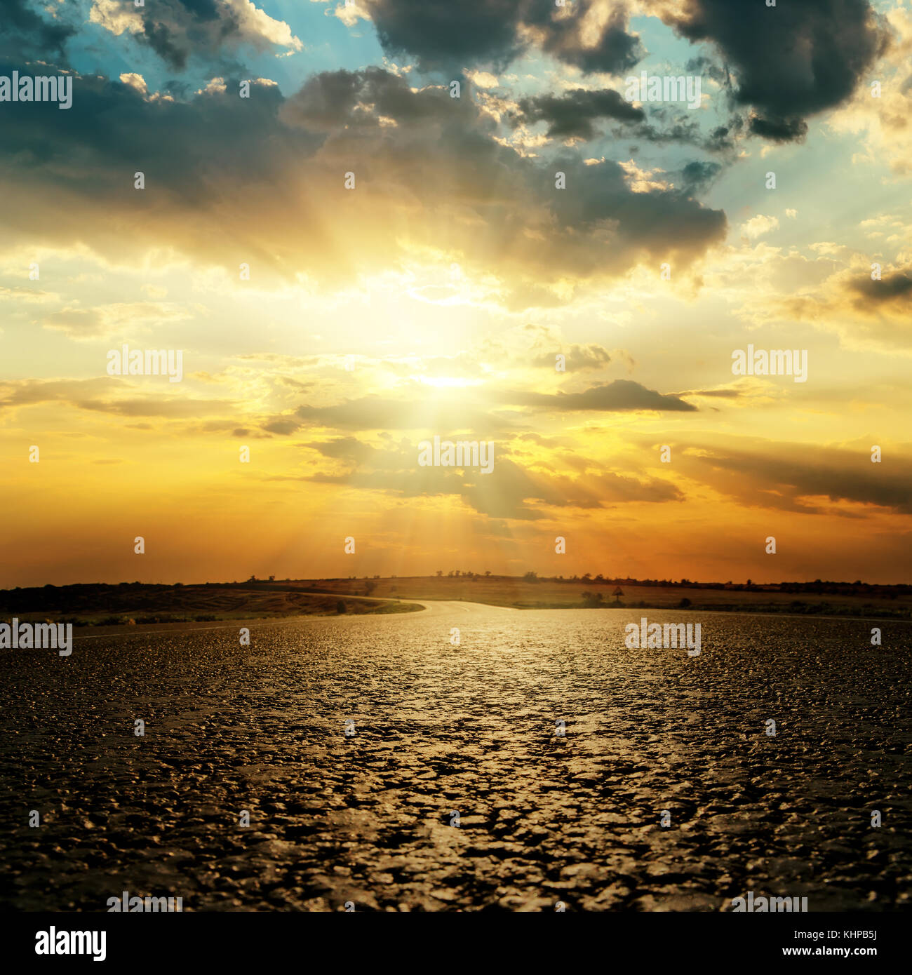 dramatic sunset over asphalt road closeup Stock Photo - Alamy