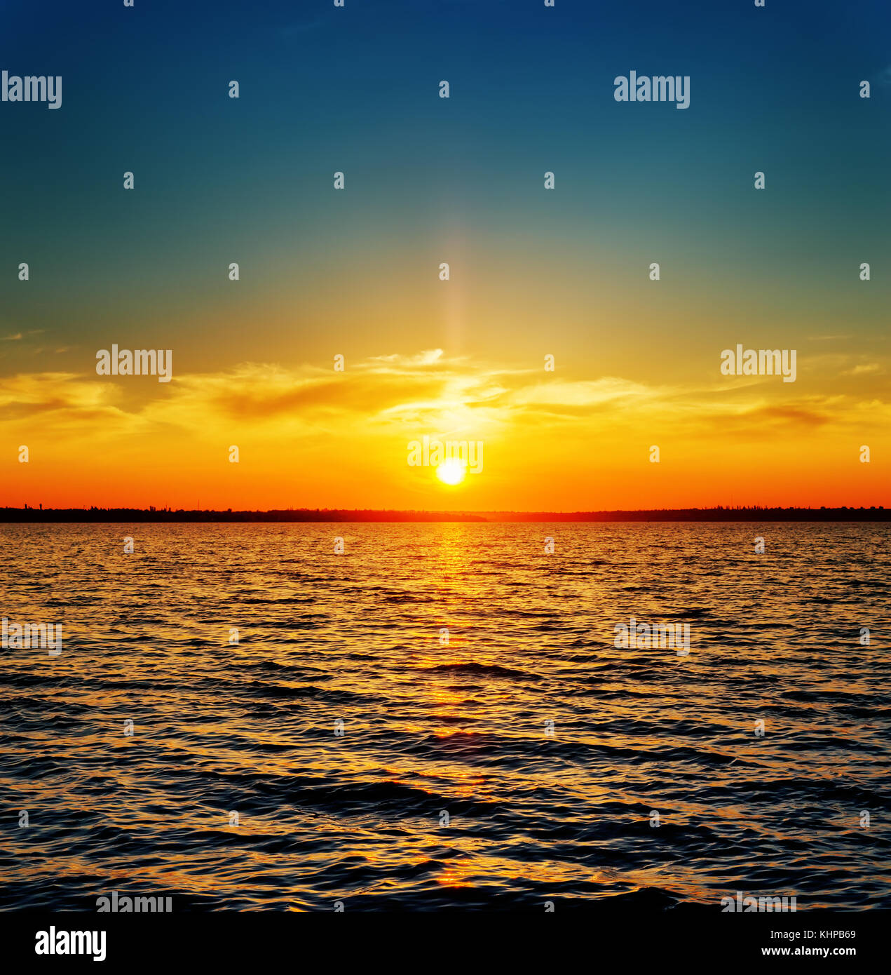 orange sunset over dark river Stock Photo - Alamy
