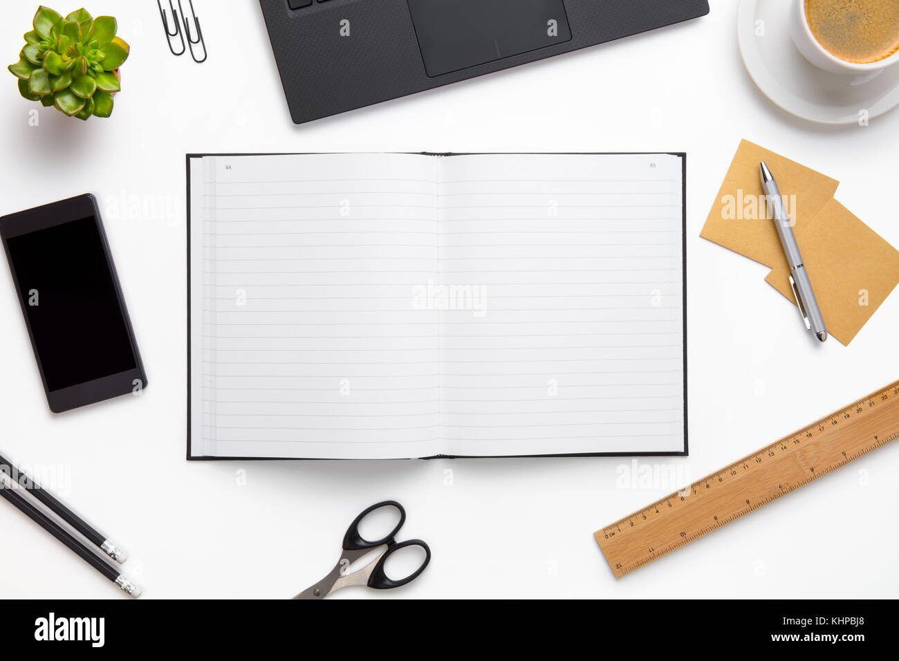 Open Diary Surrounded With Office Supplies On White Desk Stock Photo ...