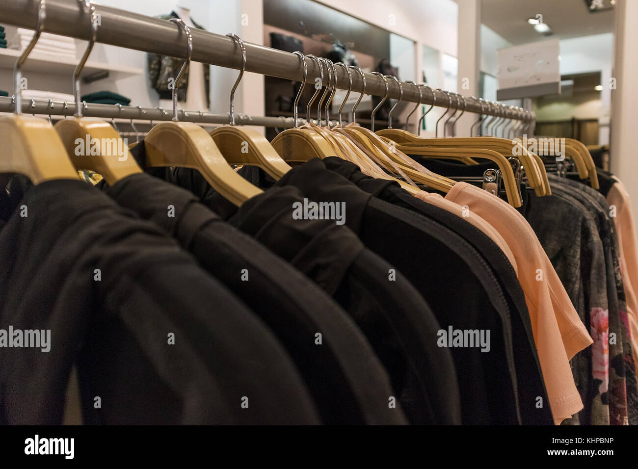 Store hanger with female clothes Stock Photo - Alamy