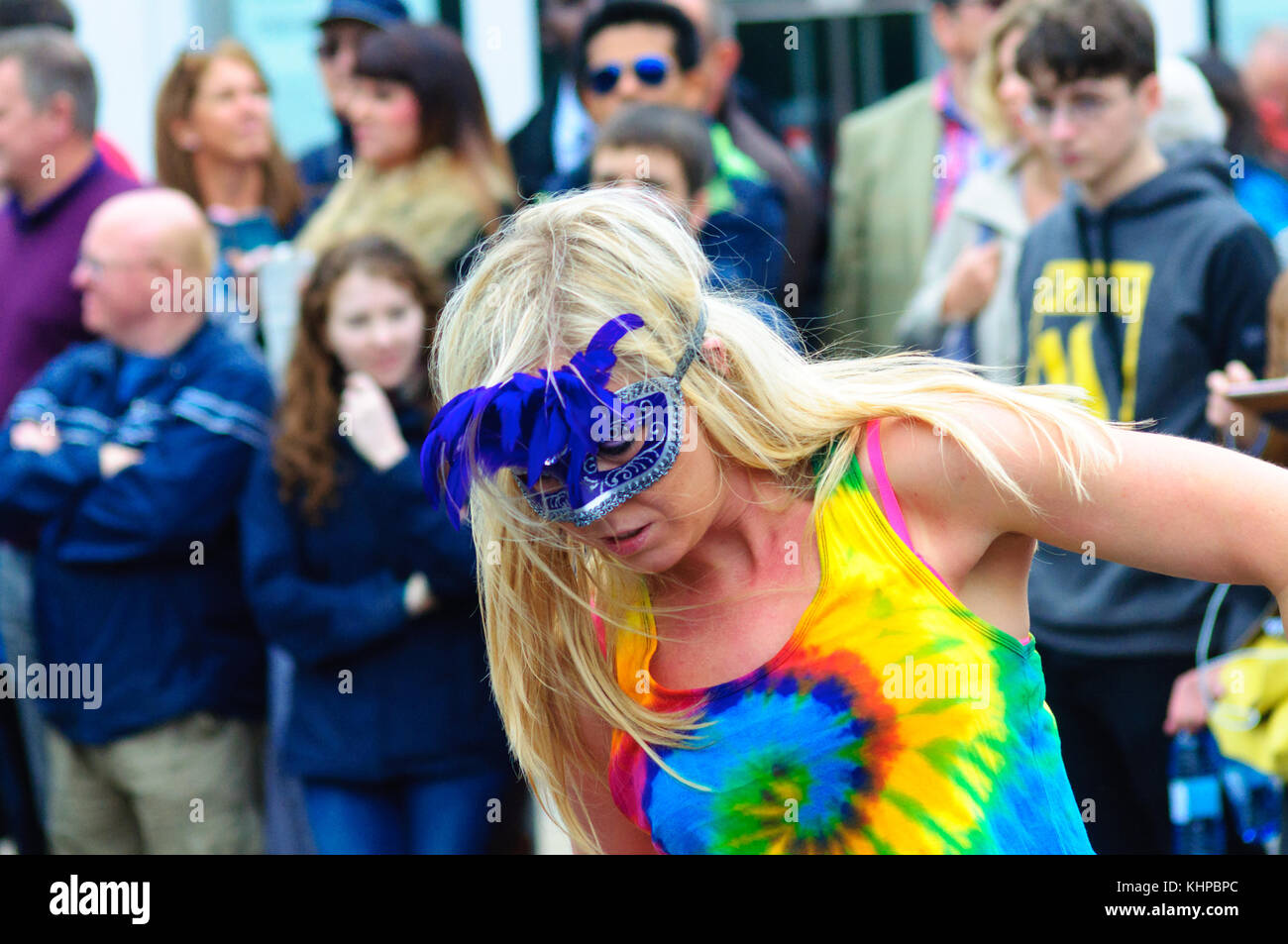 Female member of The Hula Honeys wearing a mask & performing in the ...