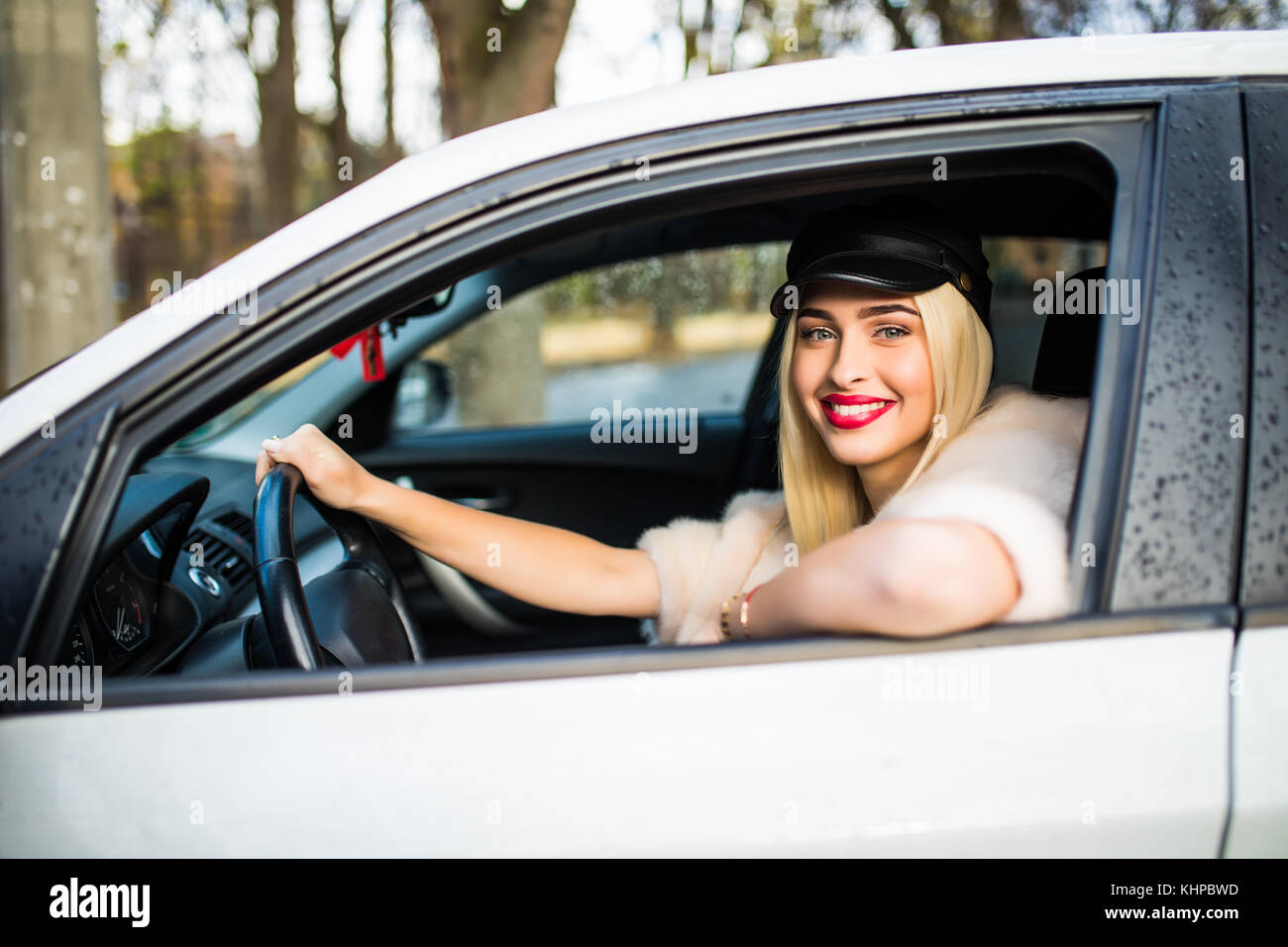 Young beauty woman driving her car in the city street Stock Photo - Alamy