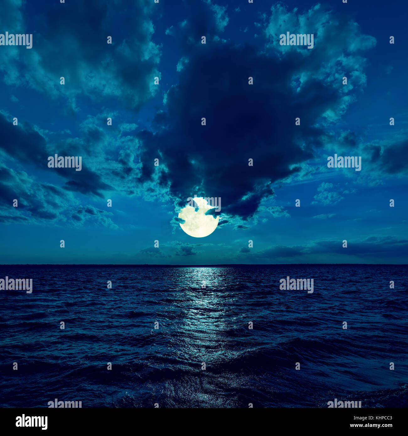 full moon in dramatic sky over water in night Stock Photo - Alamy