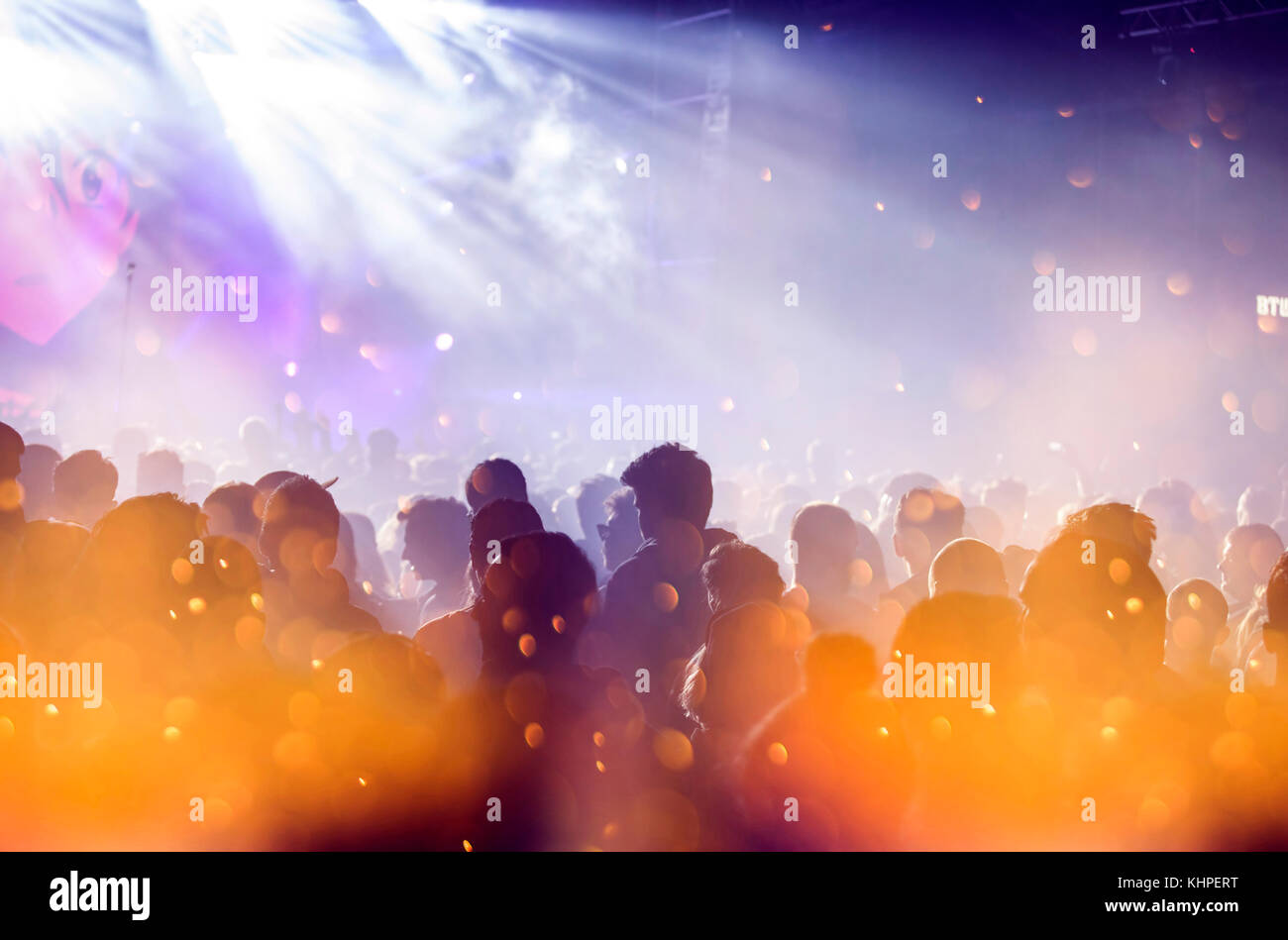 Crowd at concert - Cheering crowd in front of bright colorful stage ...