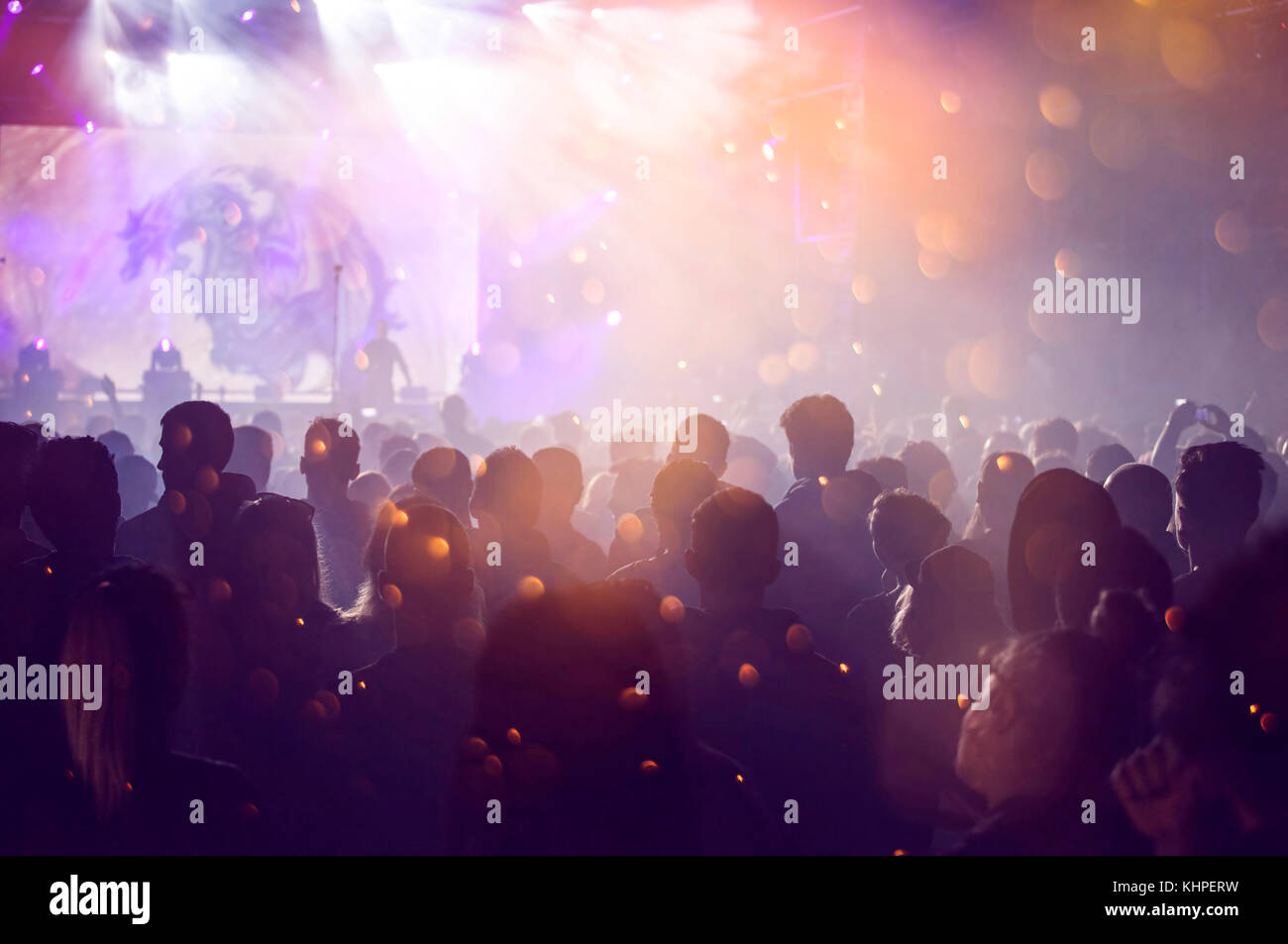 Crowd at concert - Cheering crowd in front of bright colorful stage ...