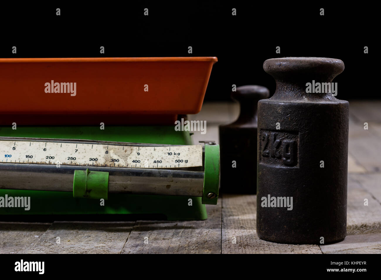 Old weight and weights on a wooden table. Old used kitchen scale with ...