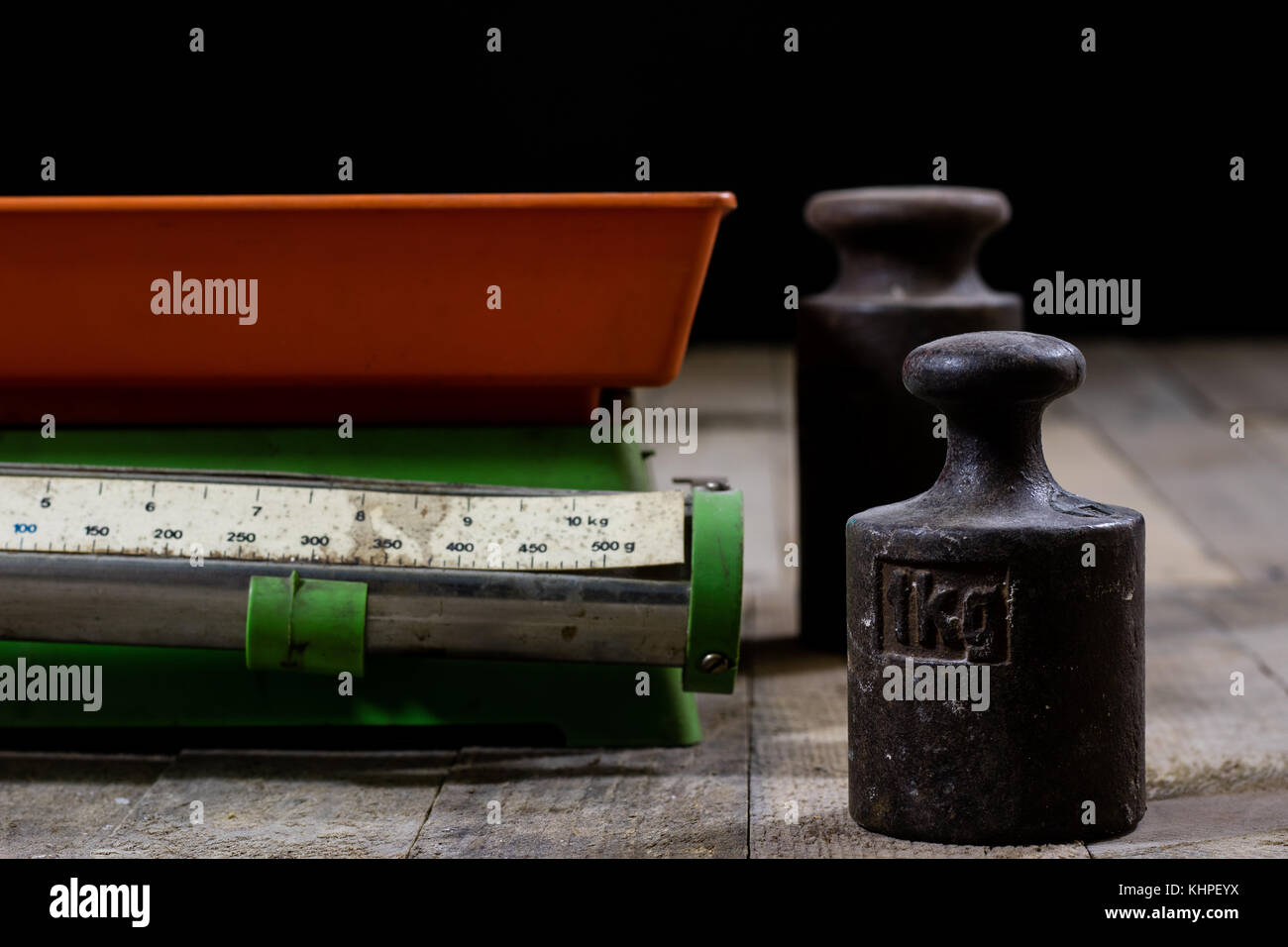 Old weight and weights on a wooden table. Old used kitchen scale with ...