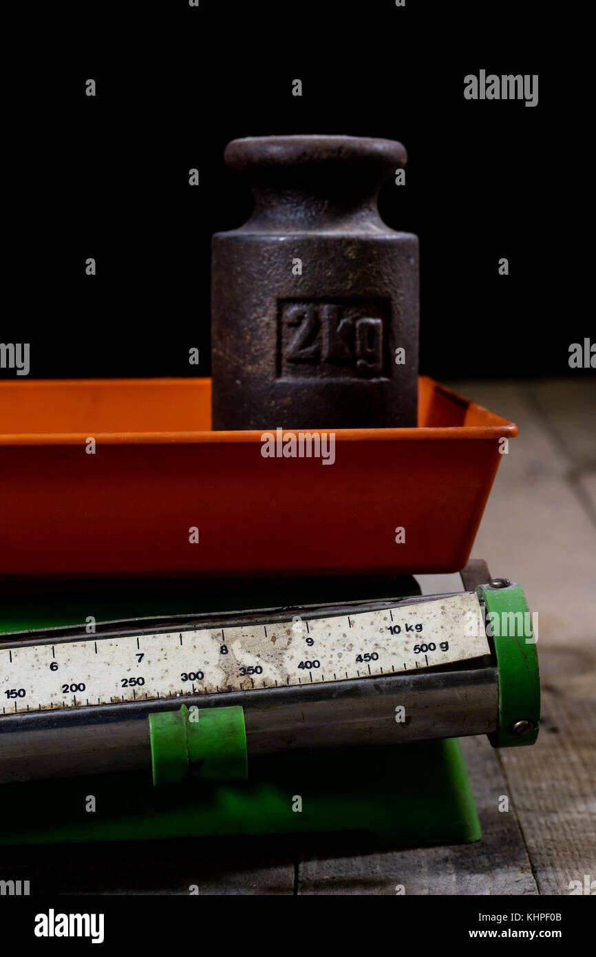 Old weight and weights on a wooden table. Old used kitchen scale with ...