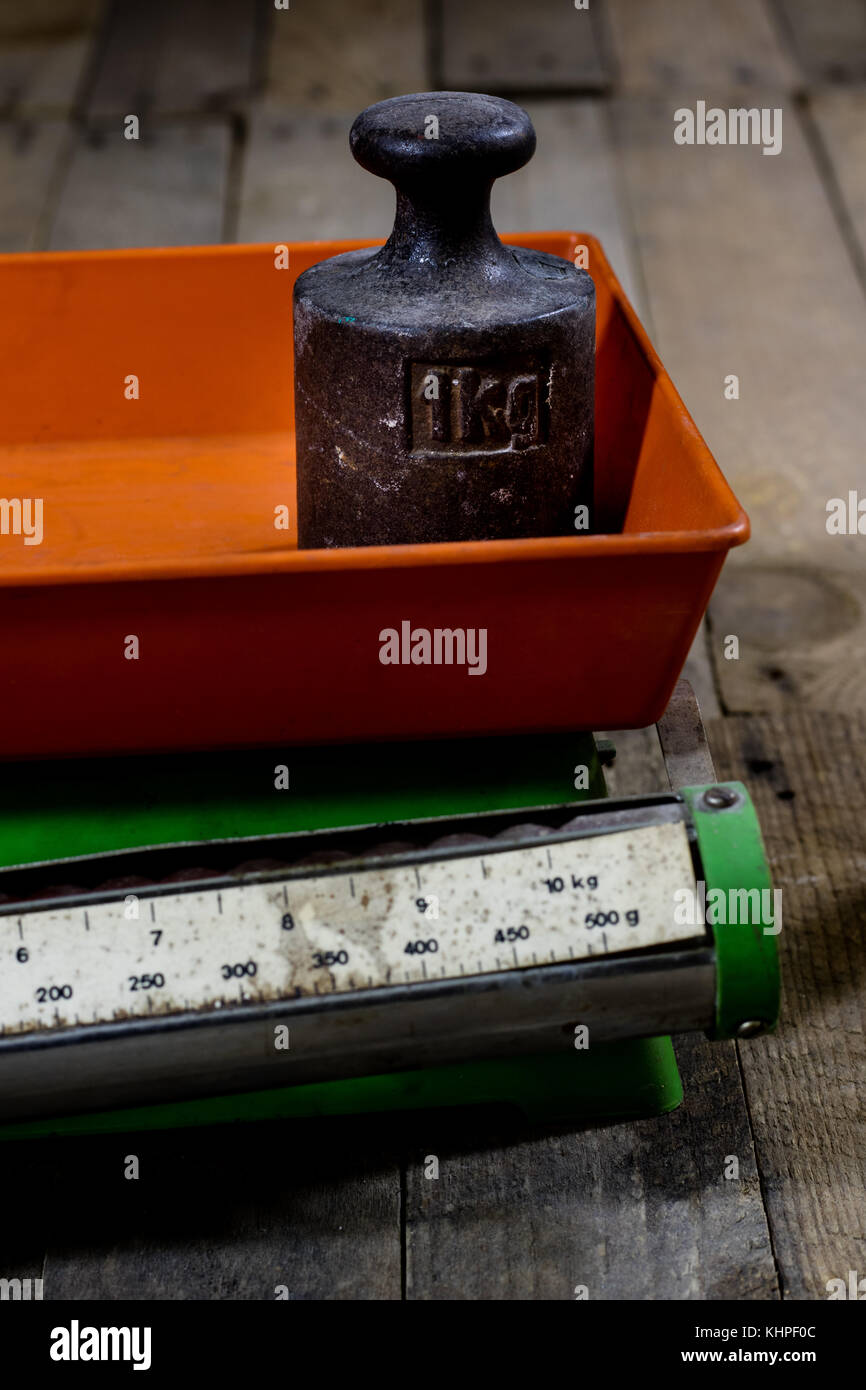 Old weight and weights on a wooden table. Old used kitchen scale with ...