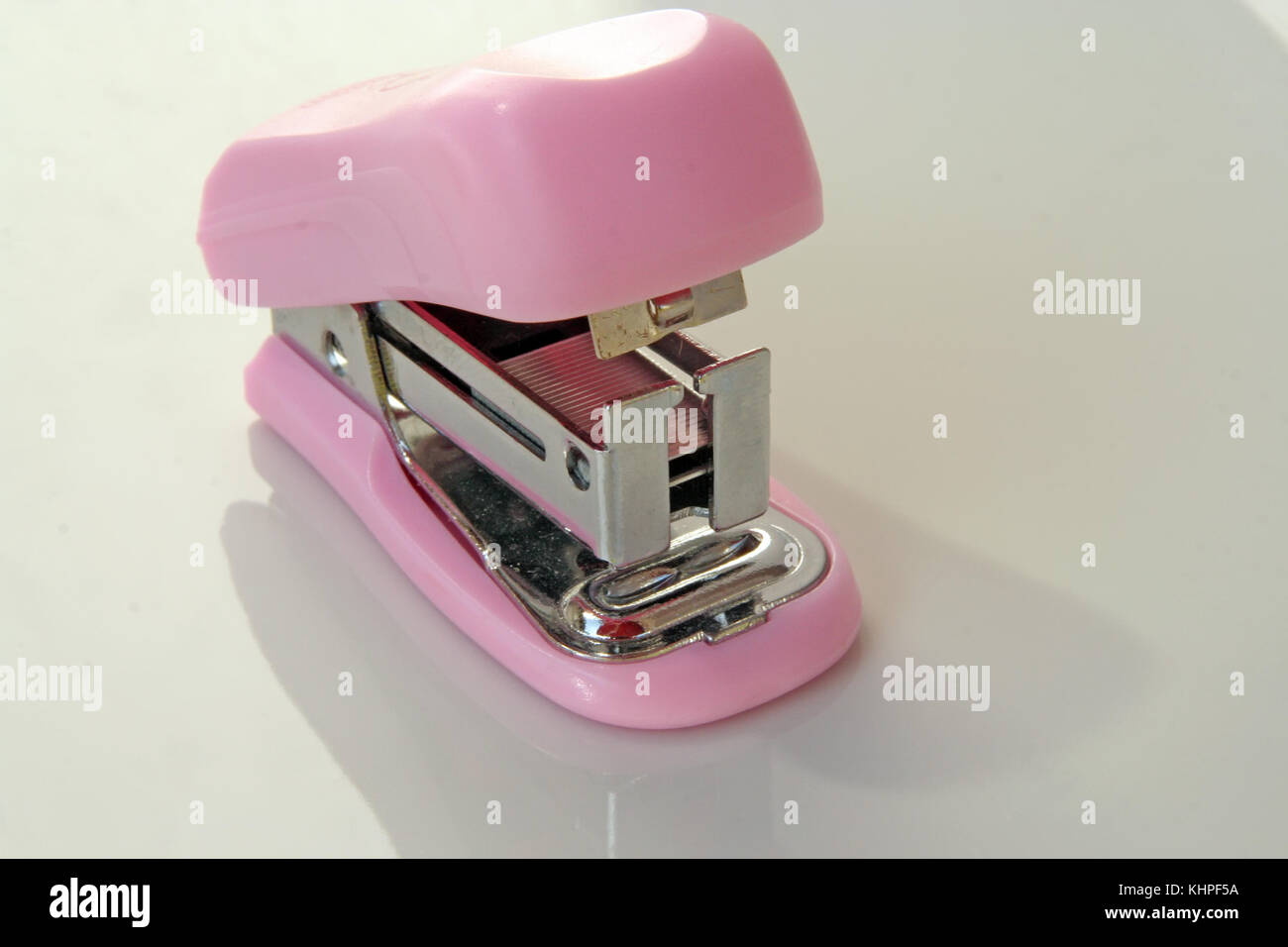 Pink stapler tool. Pink office tool Stock Photo - Alamy