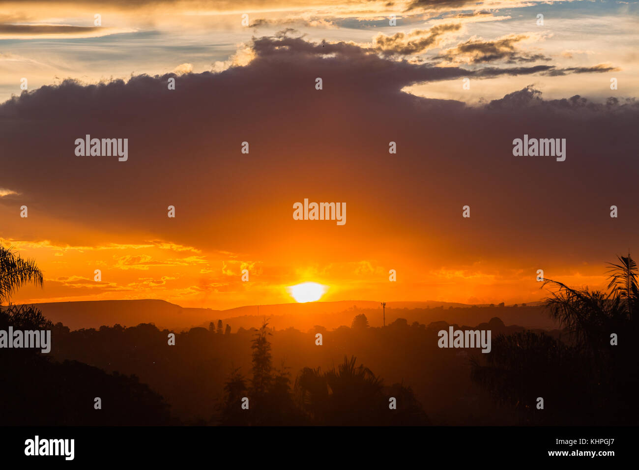 Sunset sundown clouds color contrasts over hills homes a scenic ...