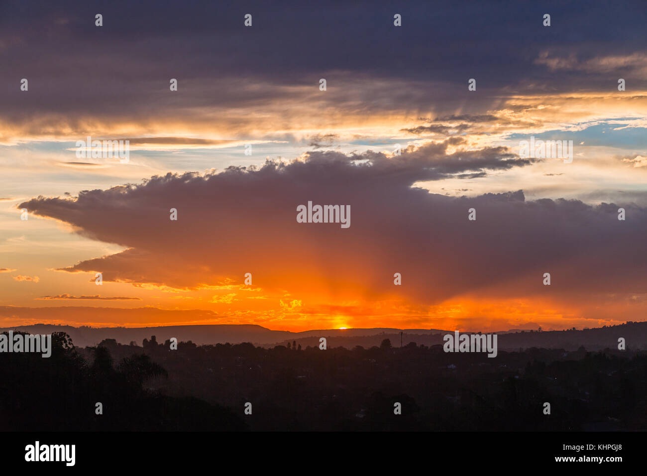 Sunset sundown clouds color contrasts over hills homes a scenic ...