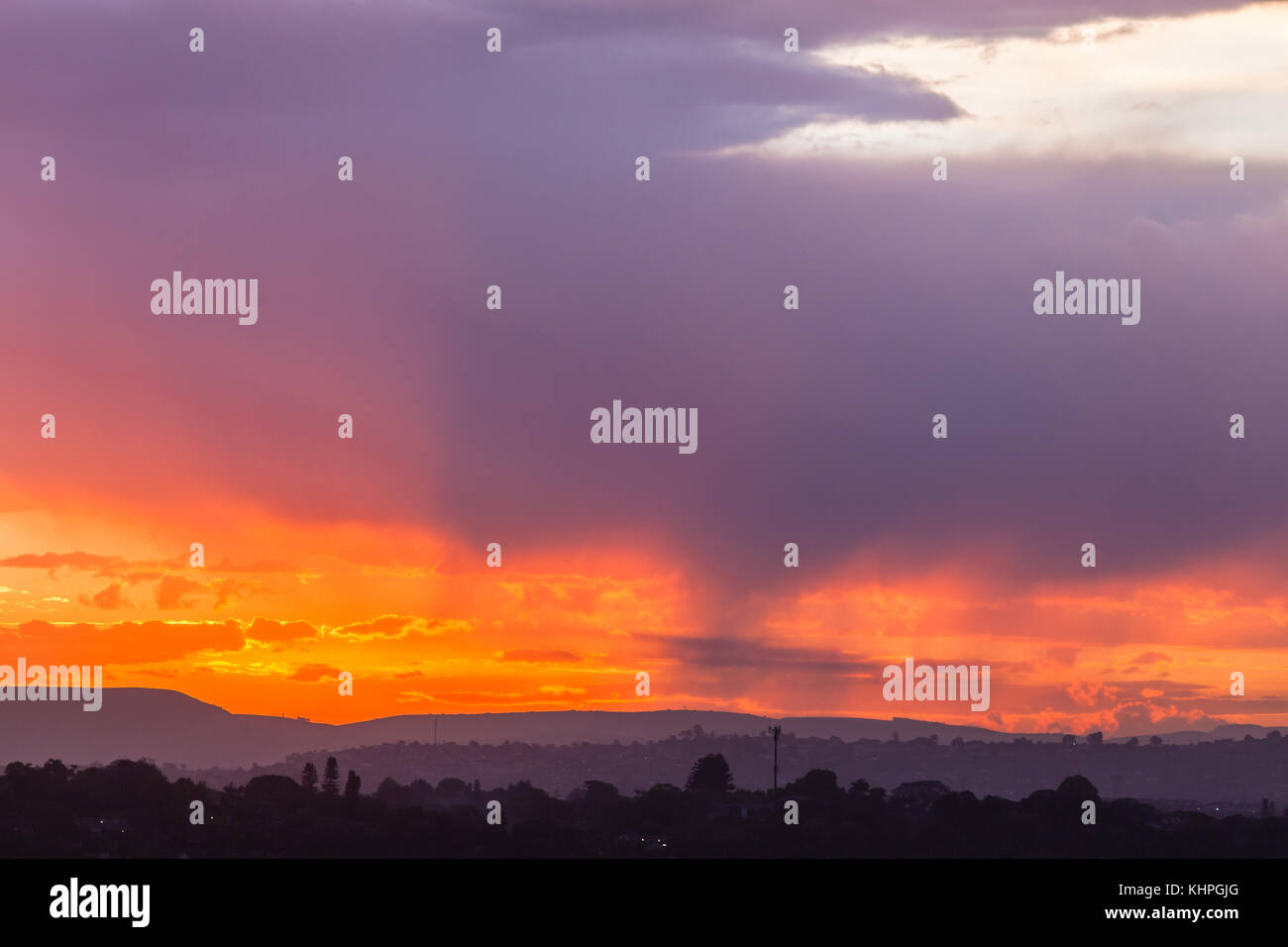 Sunset sundown clouds color contrasts over hills homes a scenic ...