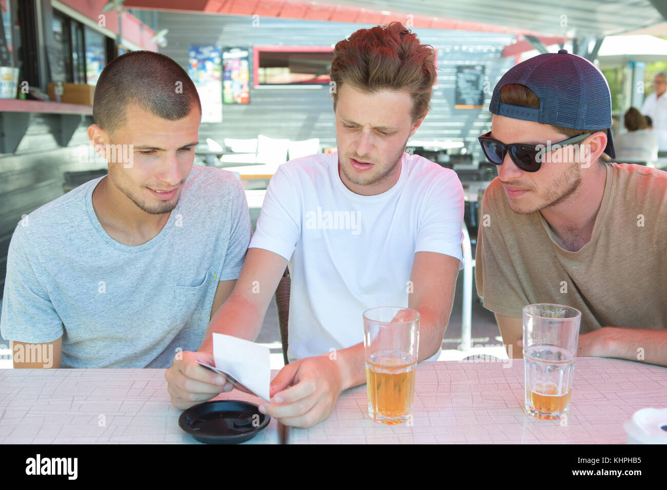 friends ready to pay bill for beers Stock Photo - Alamy
