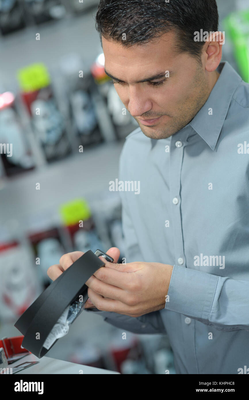 Fixing his belt hi-res stock photography and images - Alamy