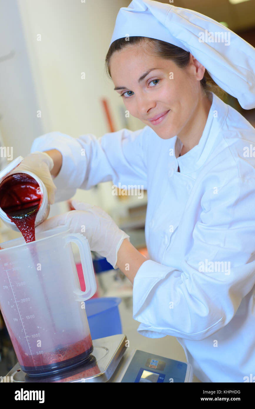 Female chef pouring fruit puree into jug Stock Photo - Alamy