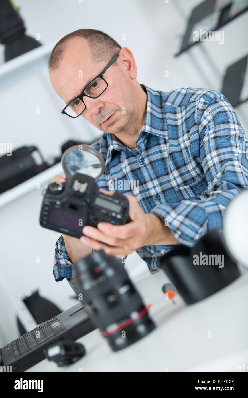 man fixing camera Stock Photo - Alamy