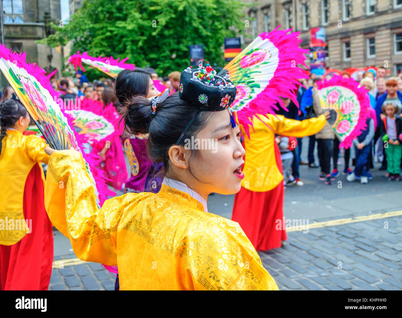 Female performers wearing costumes and dancing with fans to entertain ...