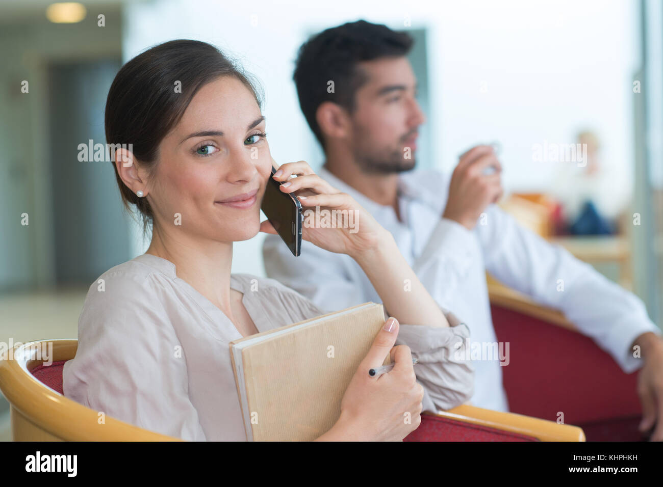businesswoman waiting with phone Stock Photo - Alamy