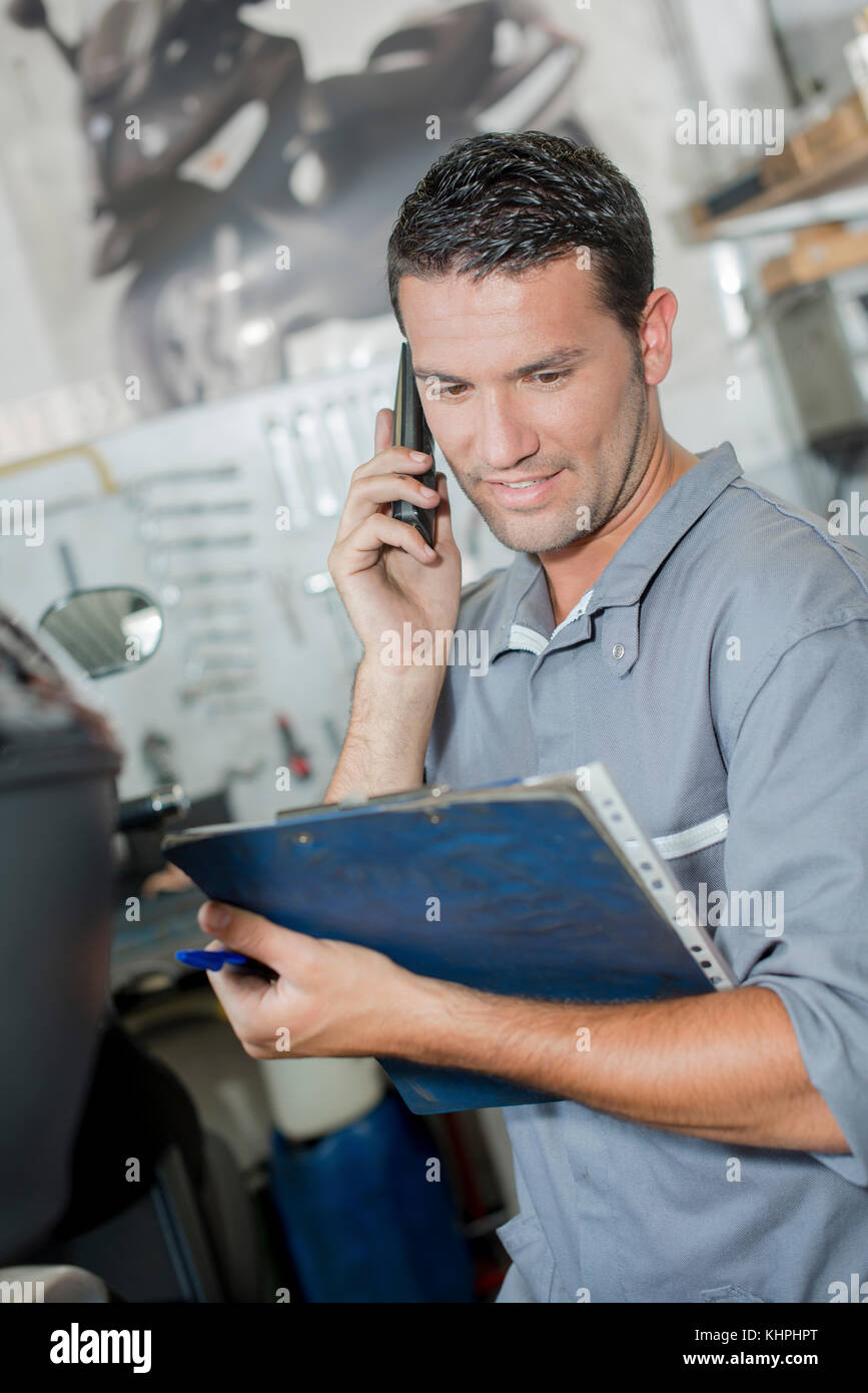 Young mechanic on the phone Stock Photo - Alamy