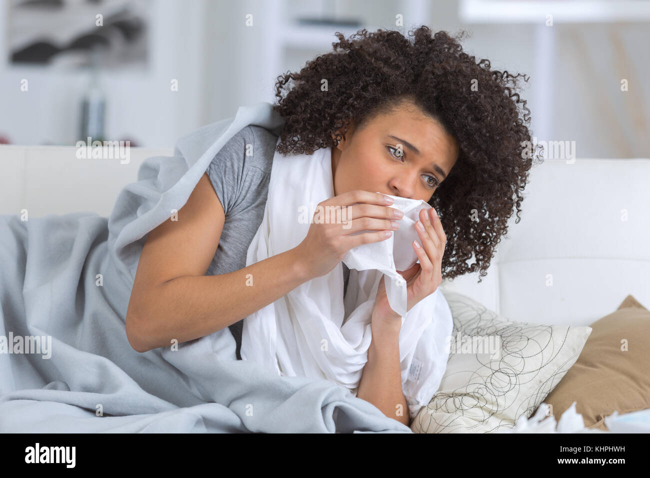 woman suffering from cold lying in bed with tissue Stock Photo - Alamy