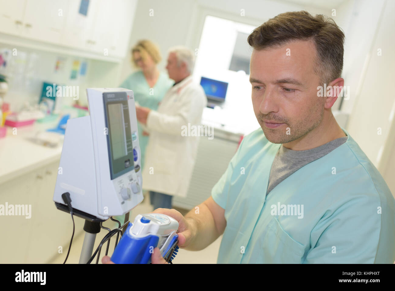 nurse inspecting a monitoring equipment Stock Photo - Alamy