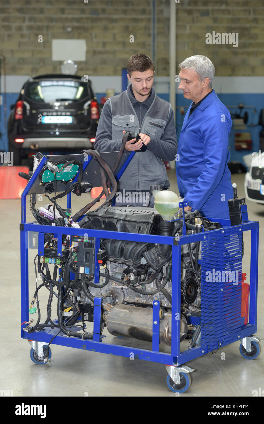 student with instructor repairing a car during apprenticeship Stock ...