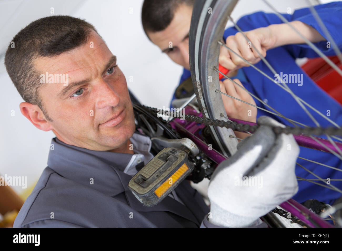 handyman before steeling bicycle frame with grinder Stock Photo - Alamy