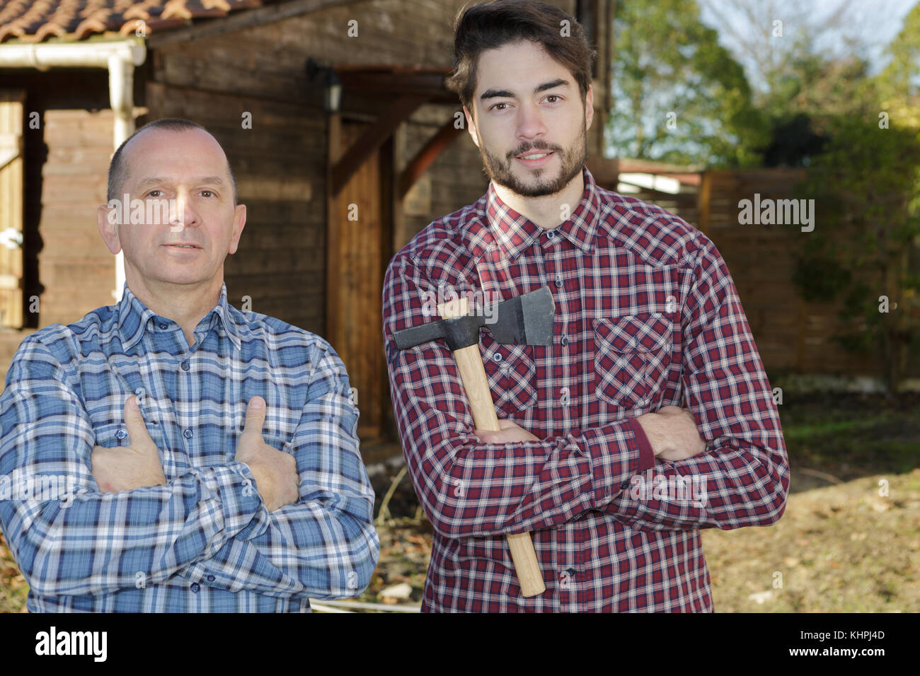 two friends lumberjacks in the forest with an axe Stock Photo - Alamy