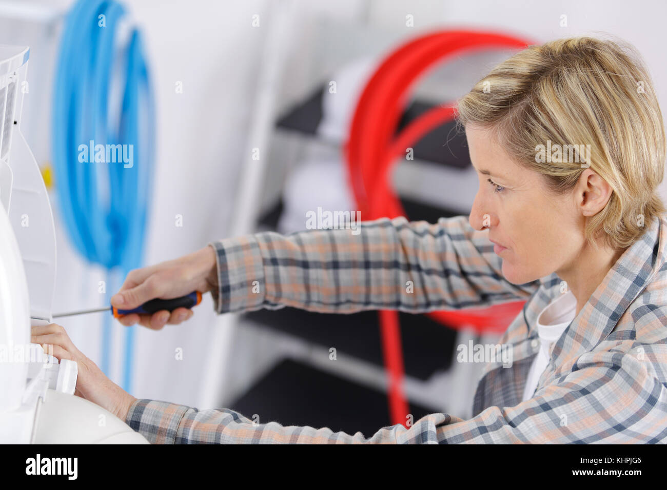 woman fixing an appliance Stock Photo - Alamy
