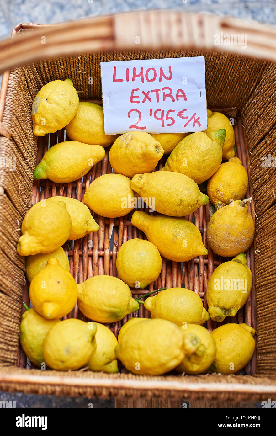 Ecological Lemons In A Wicker Basket Of A Market Cartel In Spanish ecological-lemons-in-a-wicker-basket-of-a-market-cartel-in-spanish