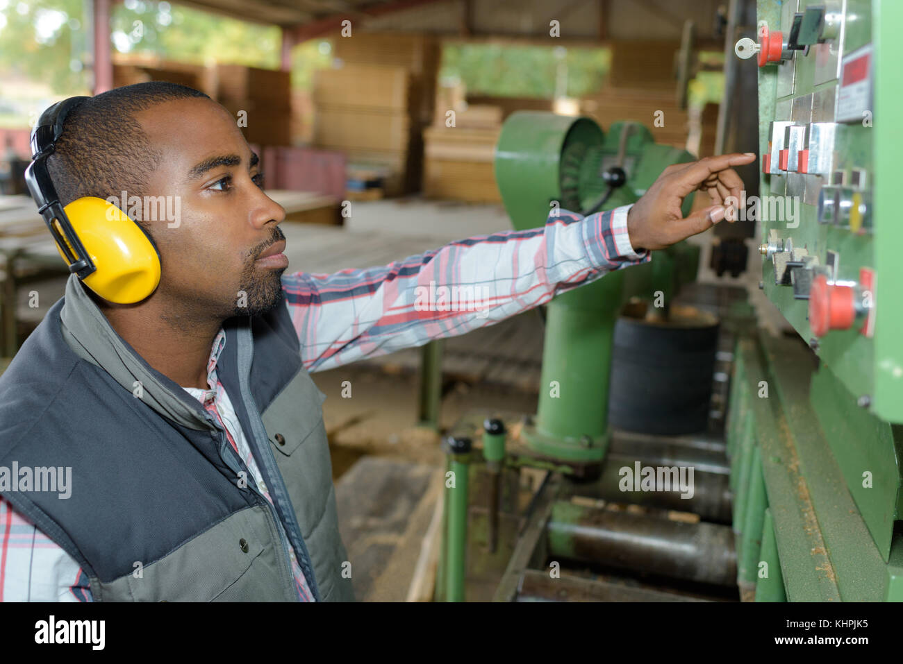 Man at machine control panel Stock Photo - Alamy