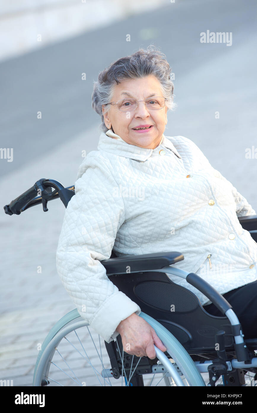 elderly disabled woman smiling in the street Stock Photo - Alamy