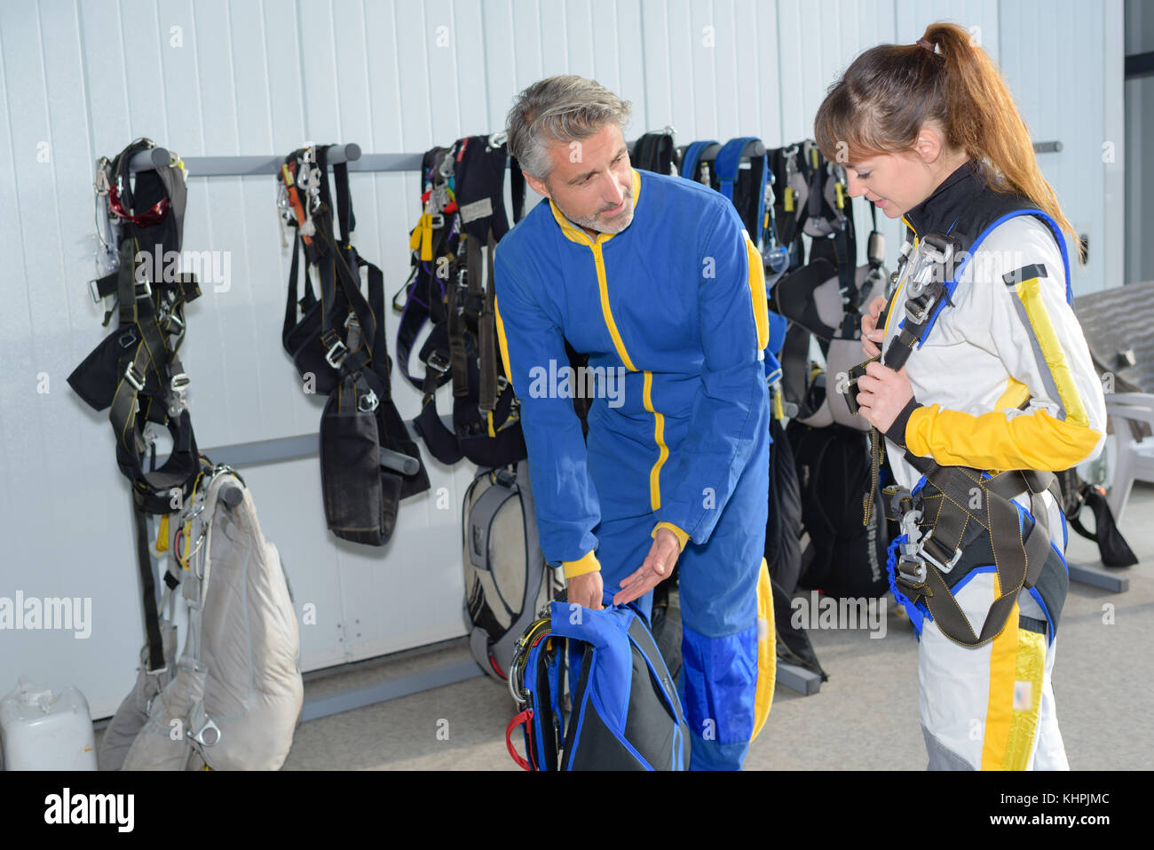 Two people preparing for parachute jump Stock Photo - Alamy