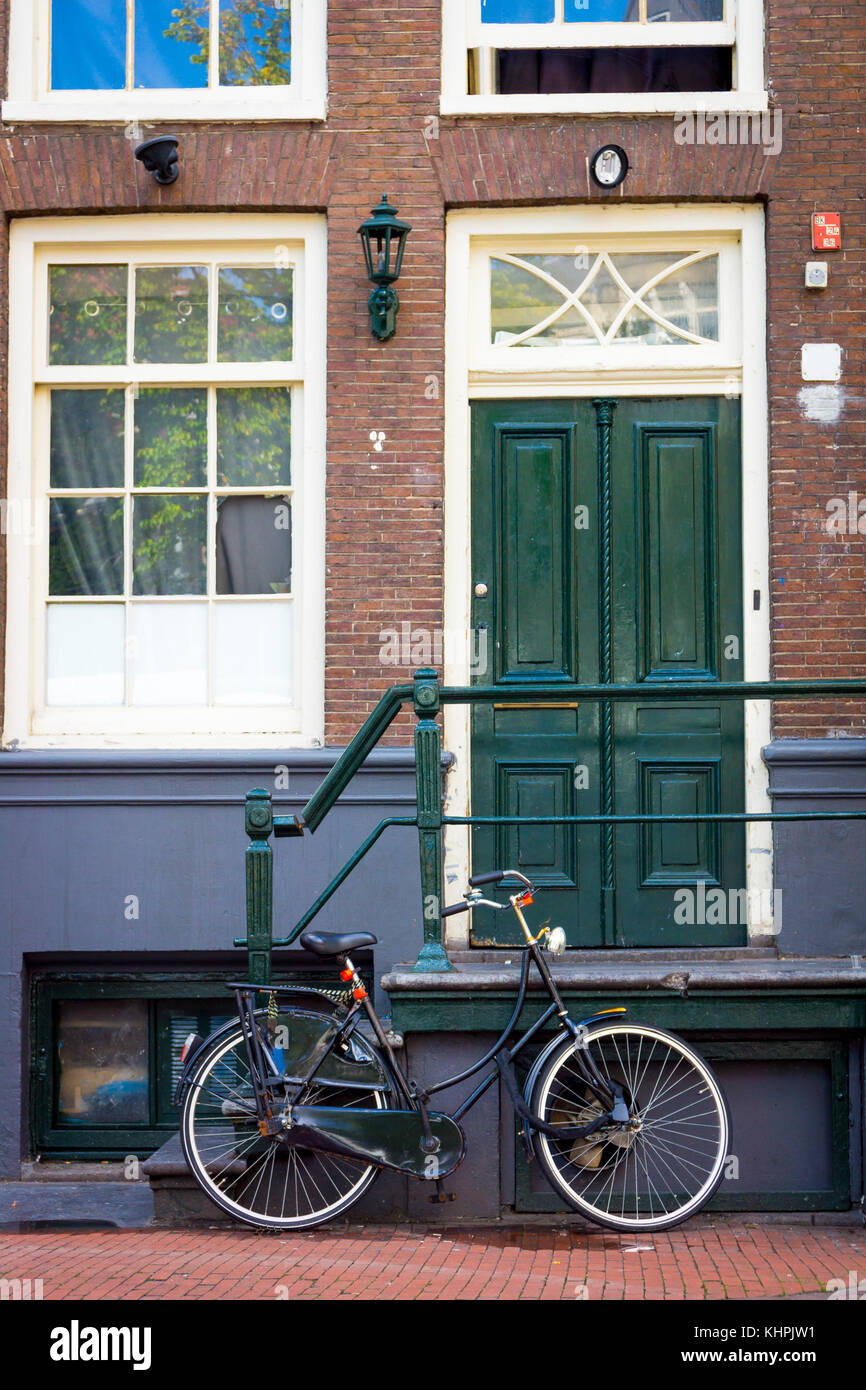 Traditional dutch bicycle parked on near brick wall in Amsterdam Stock ...
