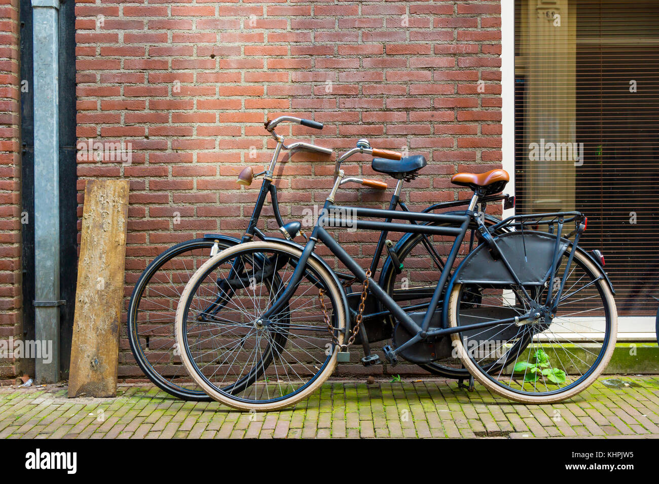 Traditional dutch bicycle parked on near brick wall in Amsterdam Stock ...