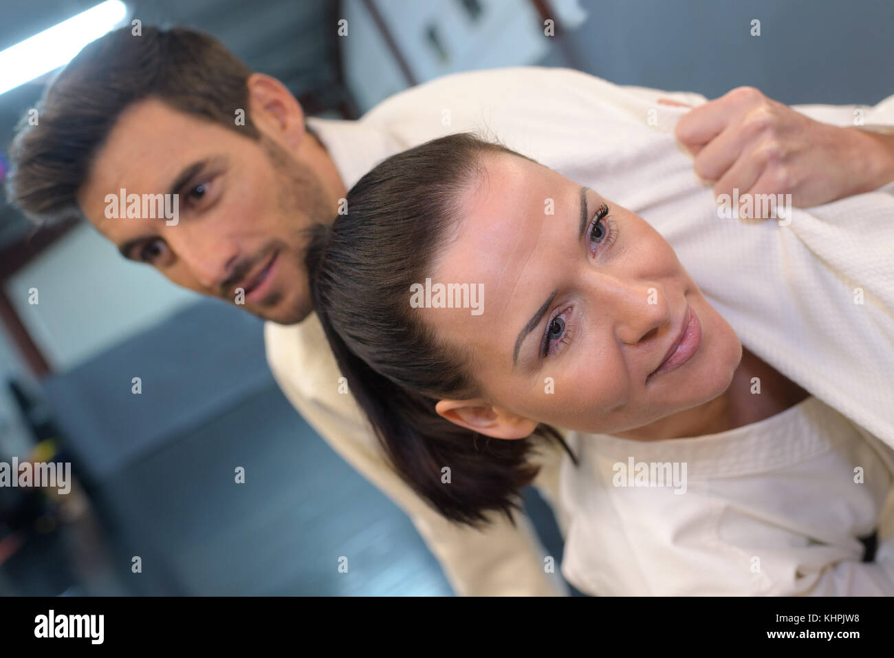 Female martial arts competitor pulling sleeve of opponent's kimono ...