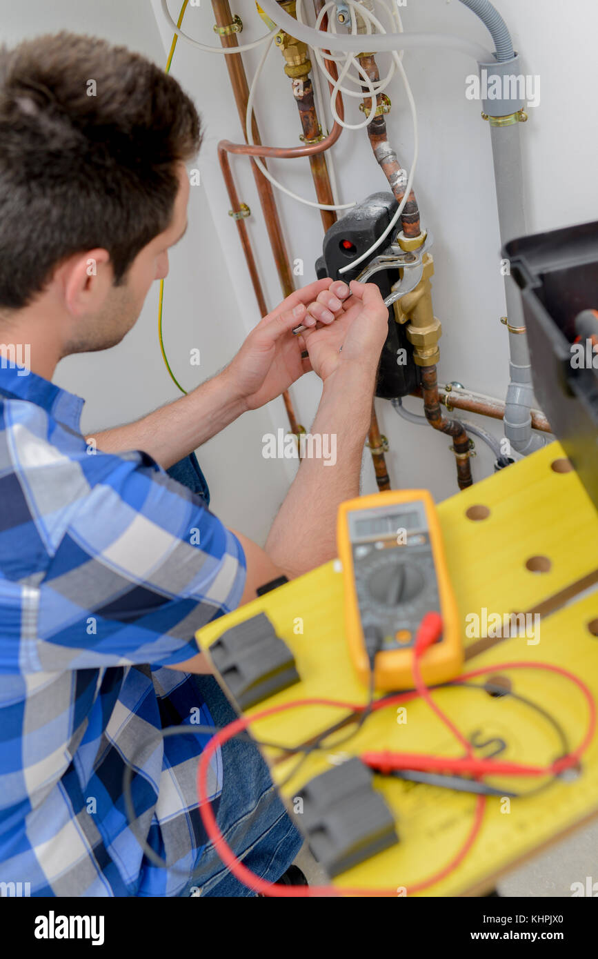 Man connecting cables Stock Photo - Alamy