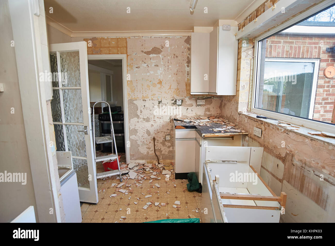 Residential property renovation, dismantling kitchen units and removing ...